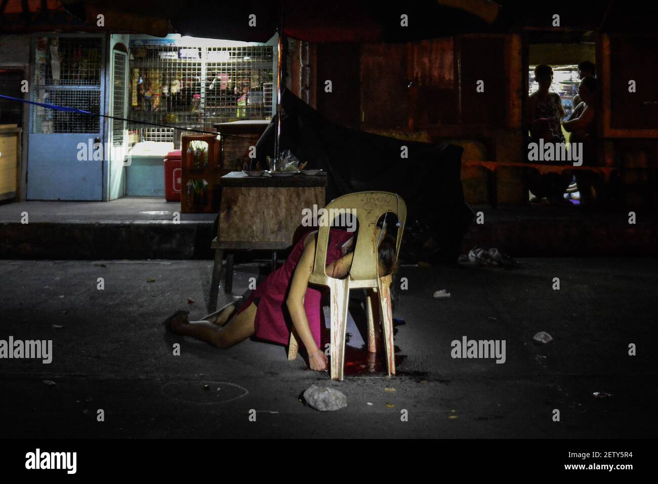 The body of Cristita Padual is slumped on a chair after she was shot ...