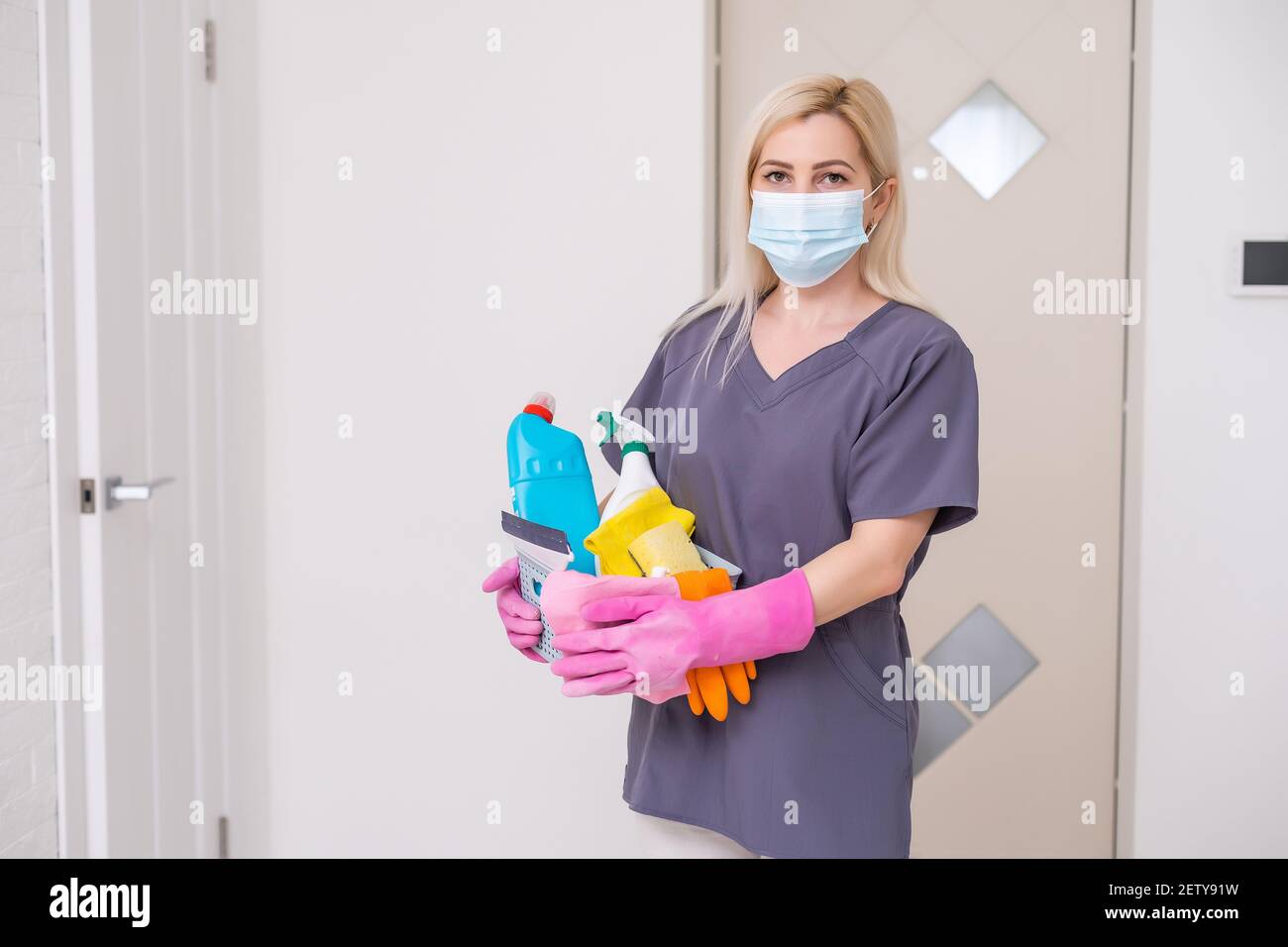 Cleaning woman working with protection mask and gloves Stock Photo - Alamy