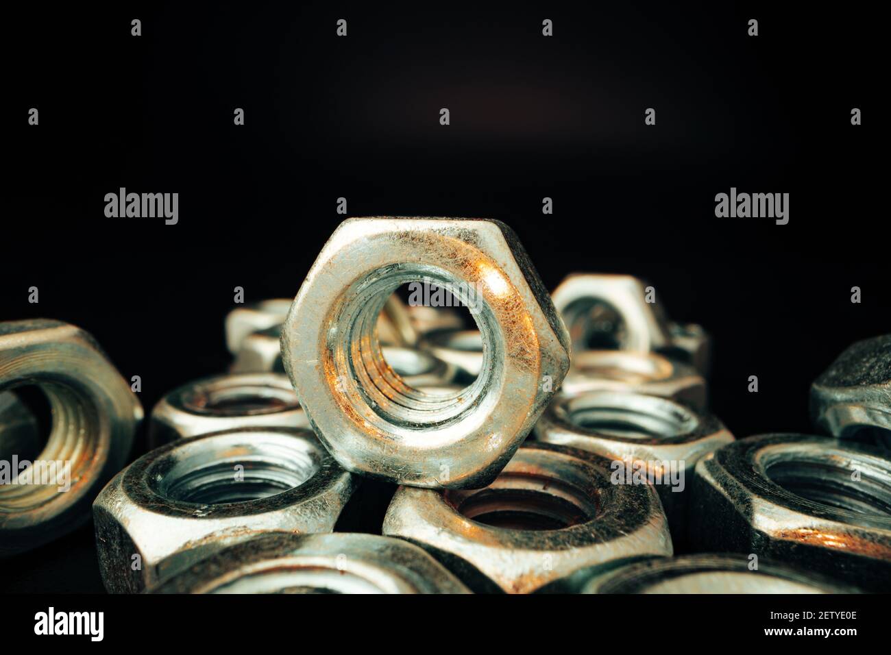 Metal nut on black background close up Stock Photo - Alamy