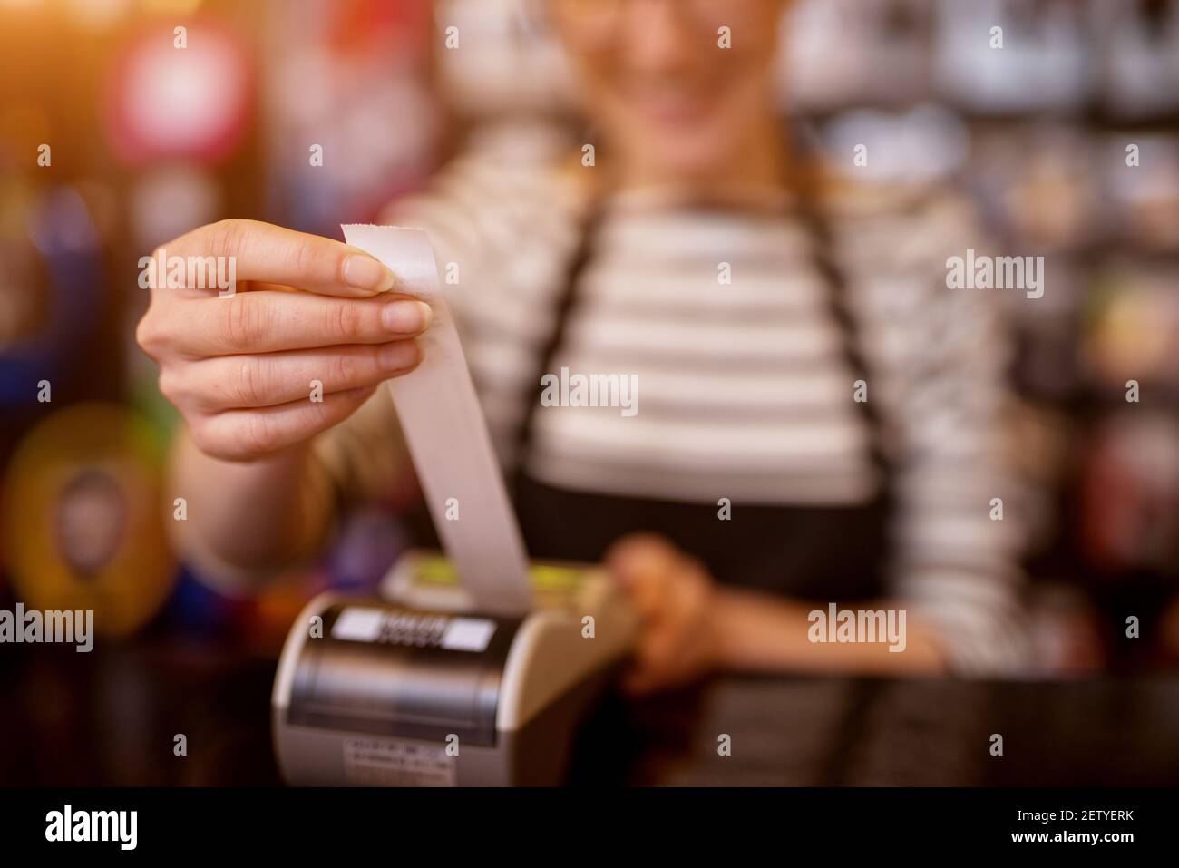 Close up focus view of woman while pulling out a check from the cashier ...