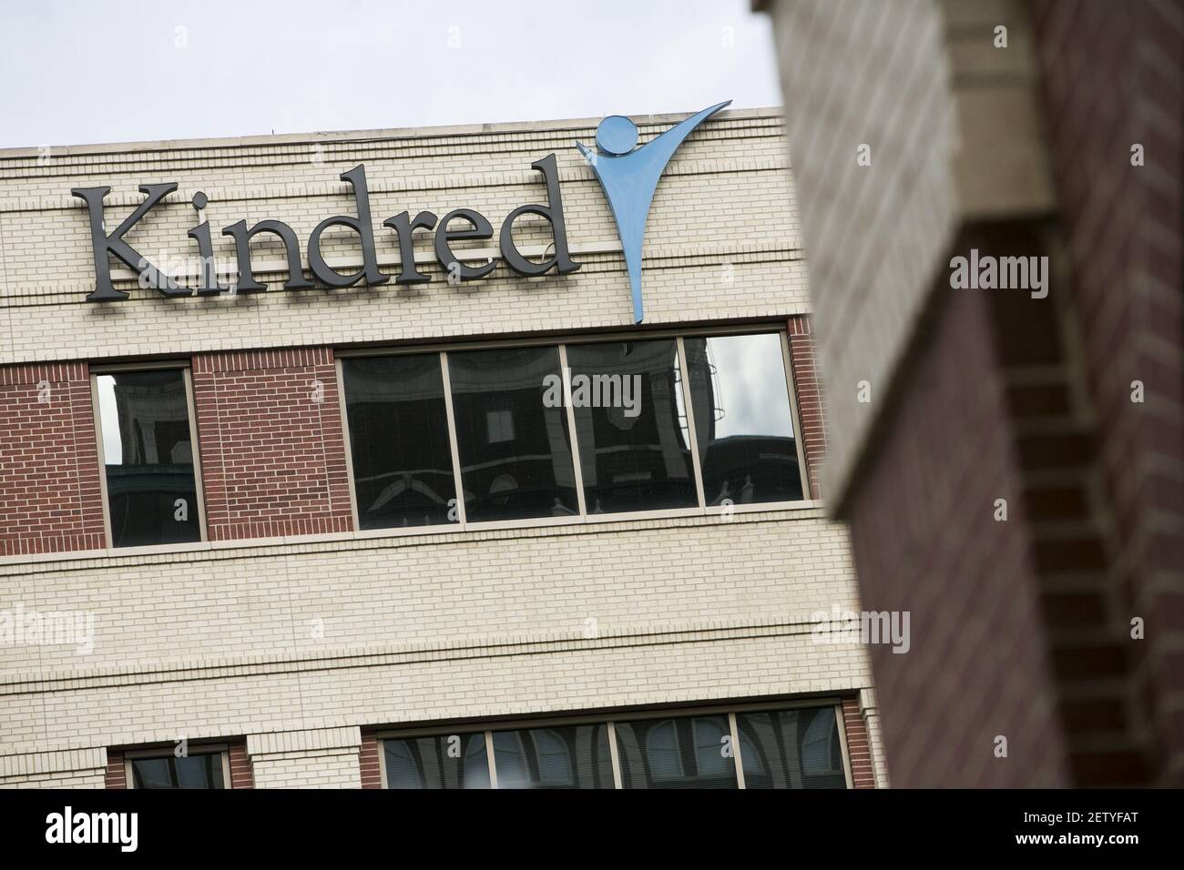 A logo sign outside of the headquarters of Kindred Healthcare in ...