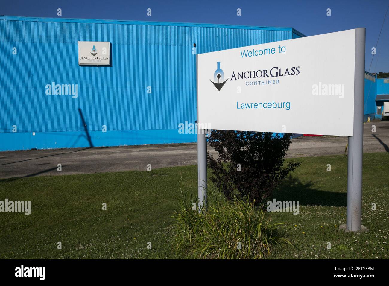 A logo sign outside of a facility occupied by Anchor Glass Container ...