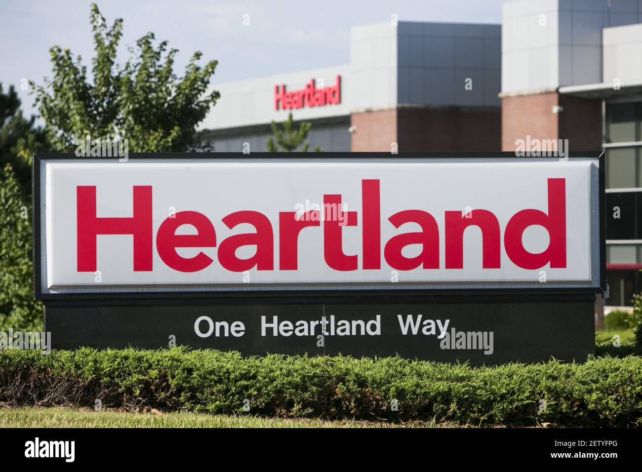 A logo sign outside of a facility occupied by Heartland Payment Systems ...