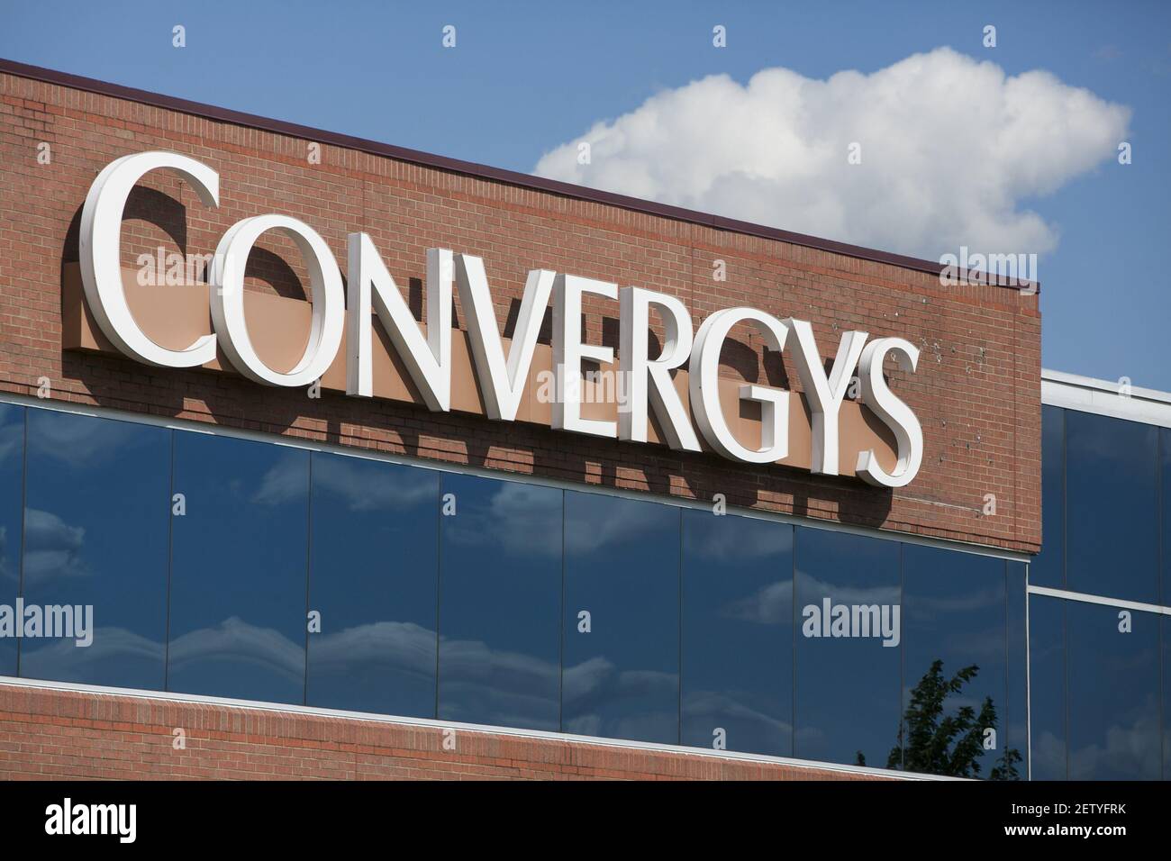 A logo sign outside of a facility occupied by the Convergys Corporation ...