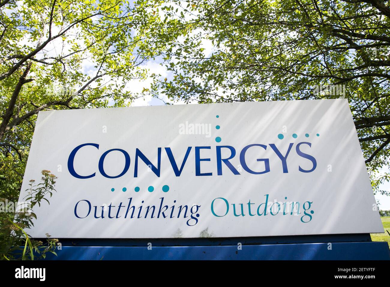 A logo sign outside of a facility occupied by the Convergys Corporation ...