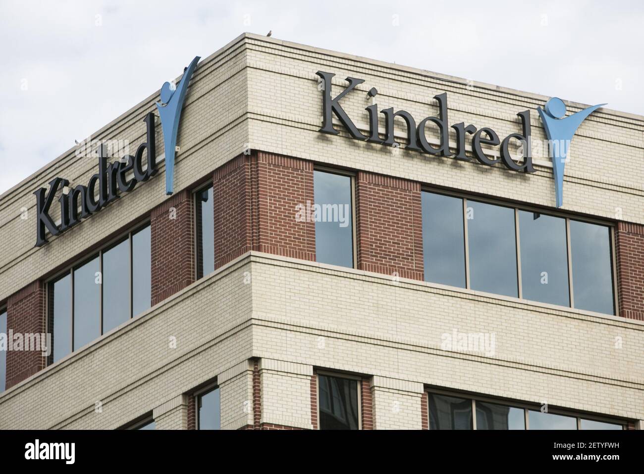A logo sign outside of the headquarters of Kindred Healthcare in ...