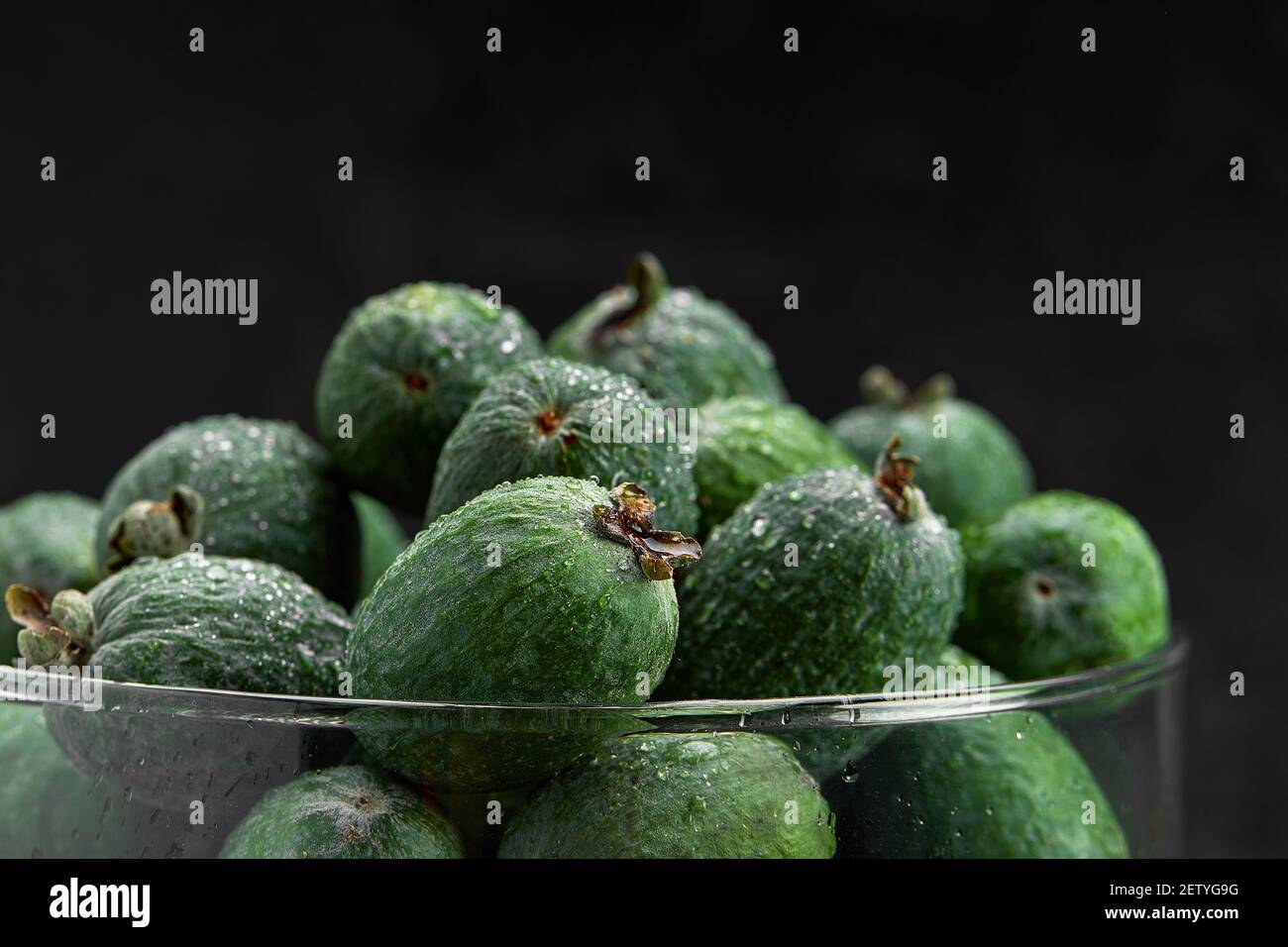 Feijoa whole on black background. Exotic fruit. Selective focus ...