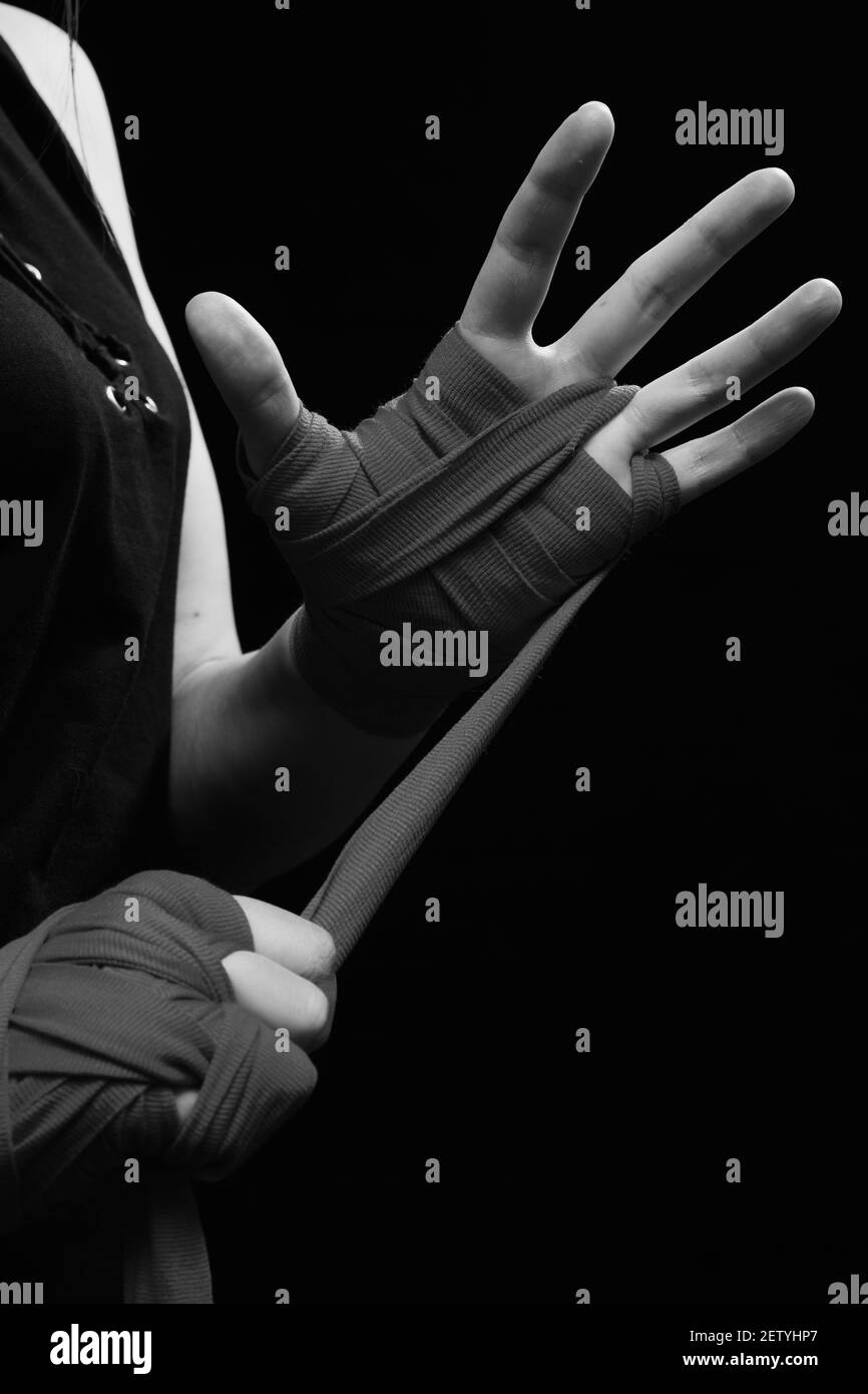 Muay Thai female boxer wearing strap on wrist closeup view. Fitness ...