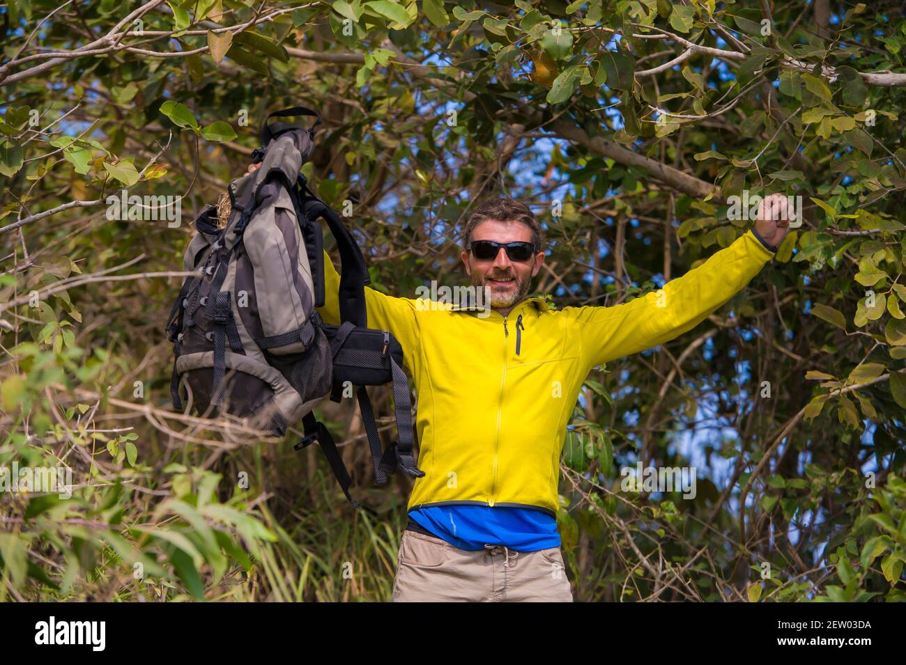 weekend outdoors - young happy and attractive hiker man with backpack ...