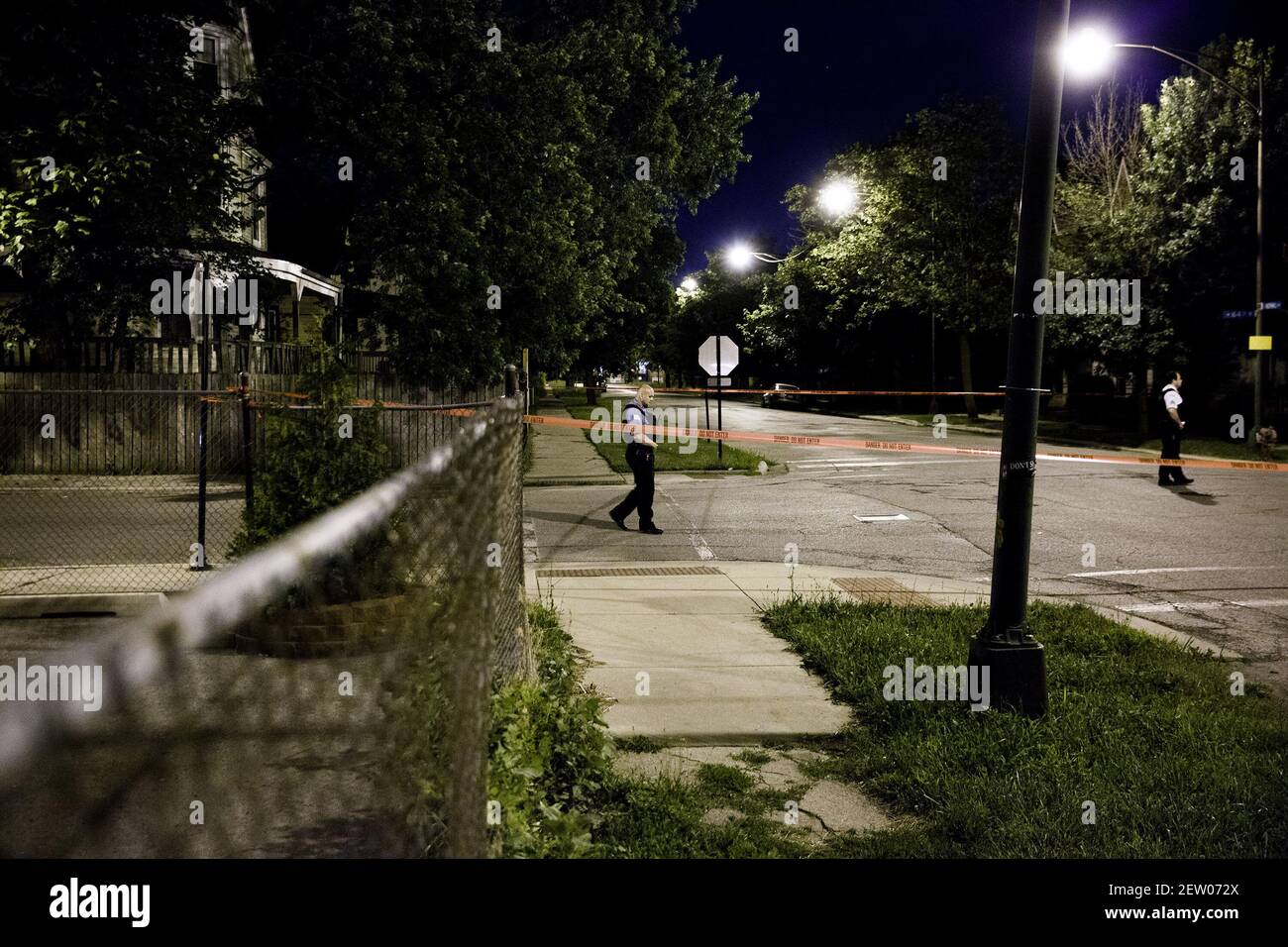 Police work the scene where a person was shot near the intersection of ...