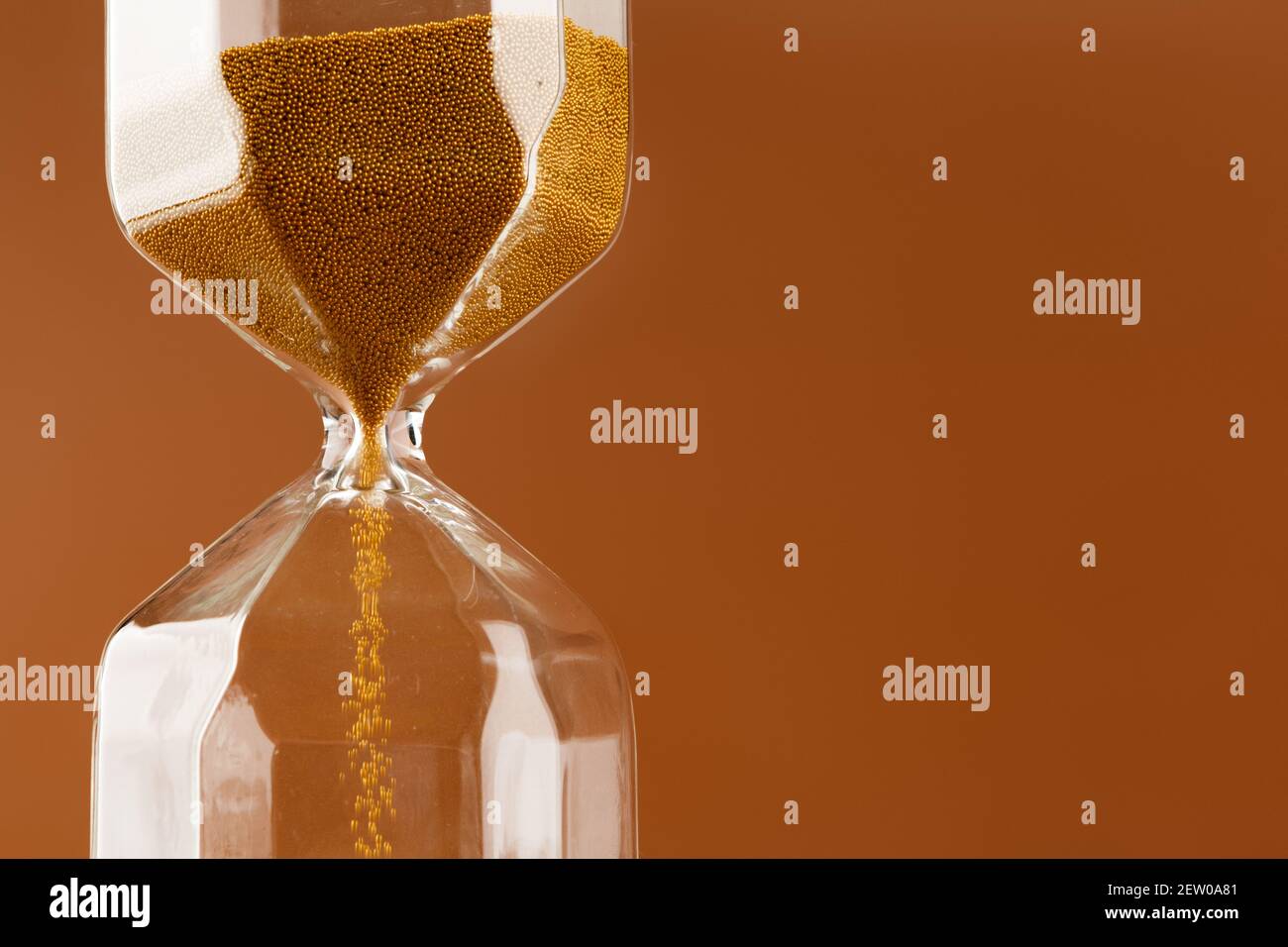 Close up of sandglass on paper background Stock Photo - Alamy