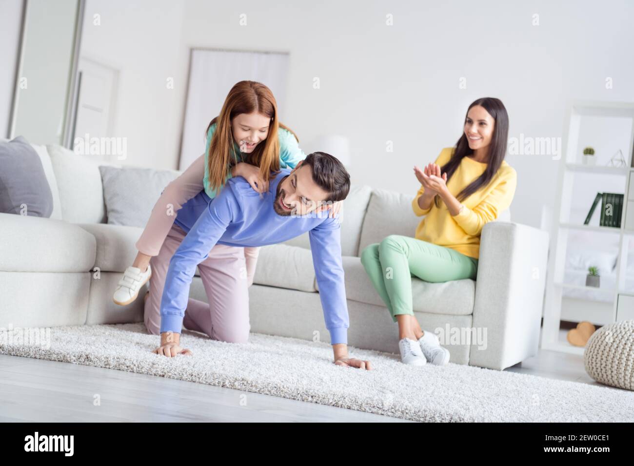 Photo Portrait Of Daughter Playing With Dad Sitting On His Back Near