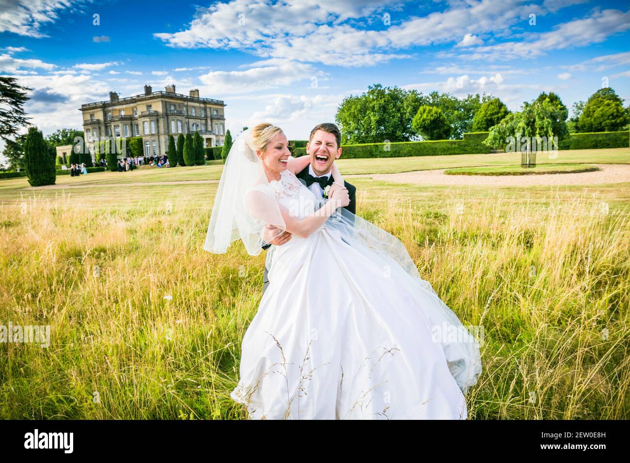 Bride and Bridegroom just married and having fun in the grounds of a ...