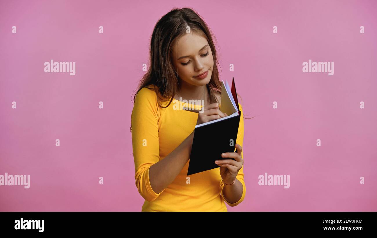 teenage girl writing in notebook and pen isolated on pink Stock Photo ...