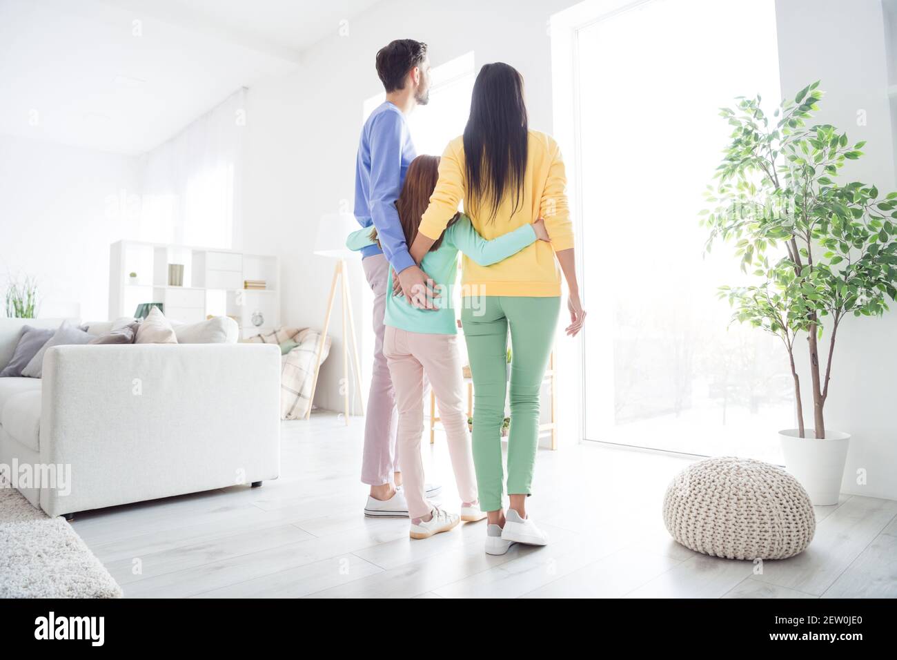 Full body rear view photo of family hug cuddle embrace look watch ...