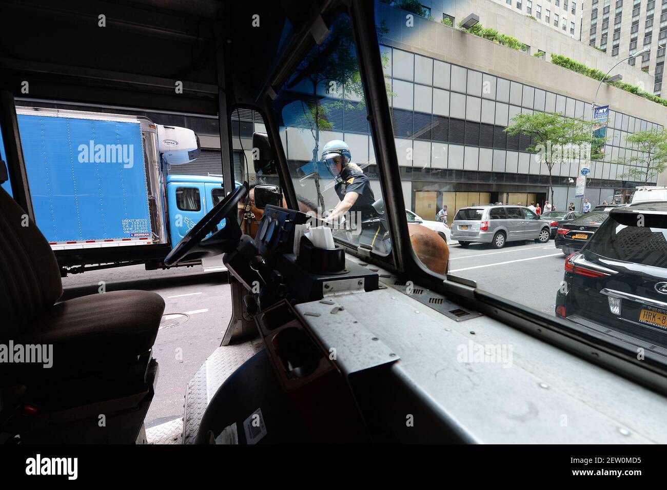 An NYPD Mounted Unit Police officer places a parking violation ticket ...