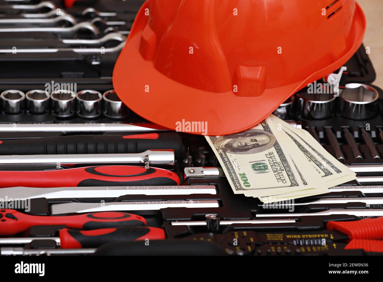 Toolbox, tools kit detail, dollar bills and orange protective helmet ...