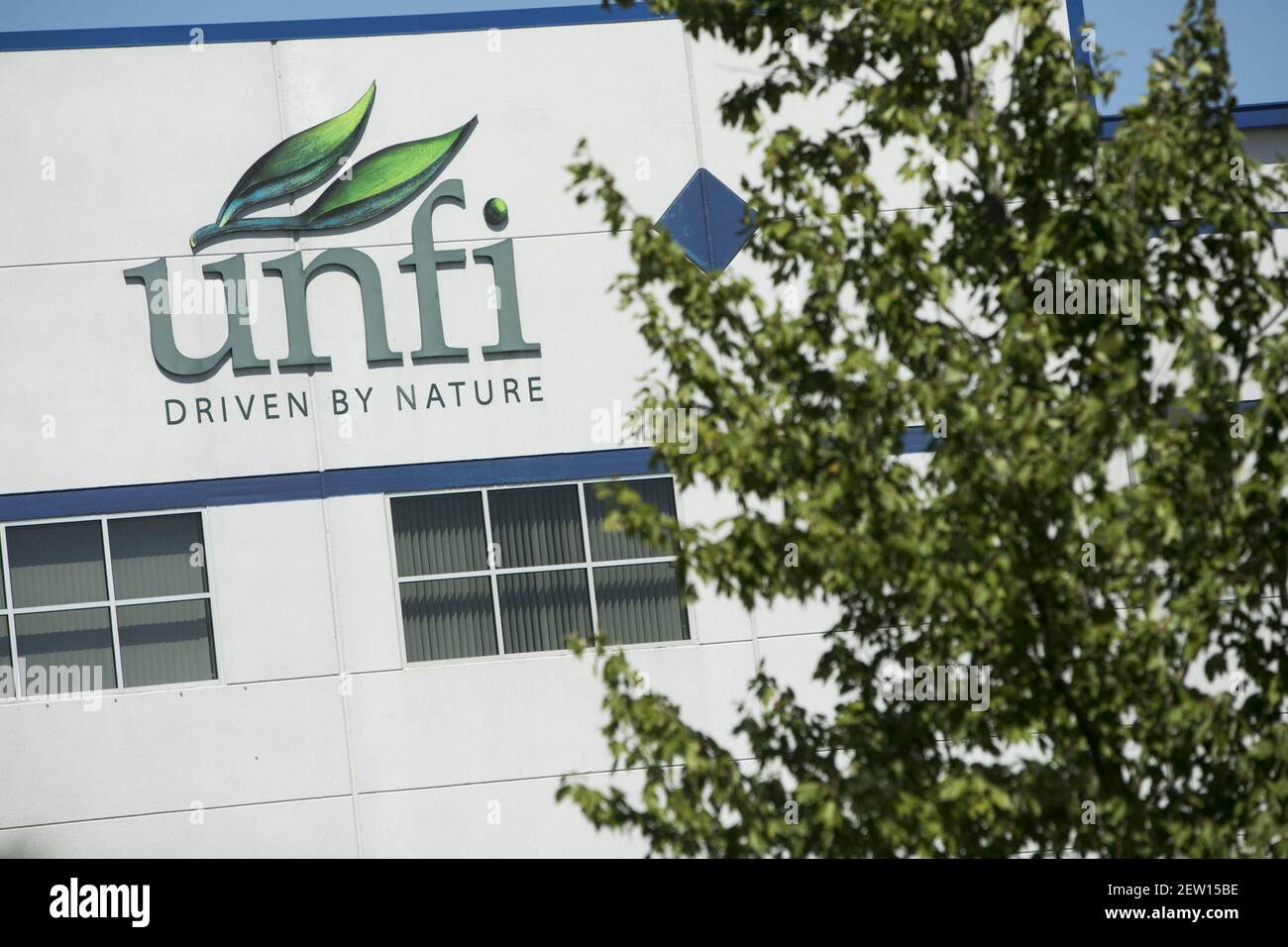 A logo sign outside of a facility occupied by United Natural Foods ...