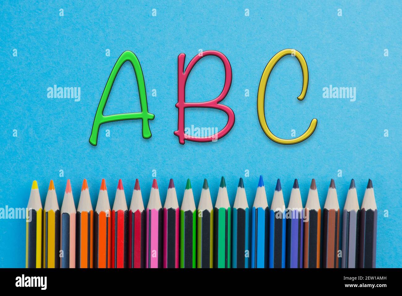 colored pencils in a row, above the colored capital letters ABC Stock ...
