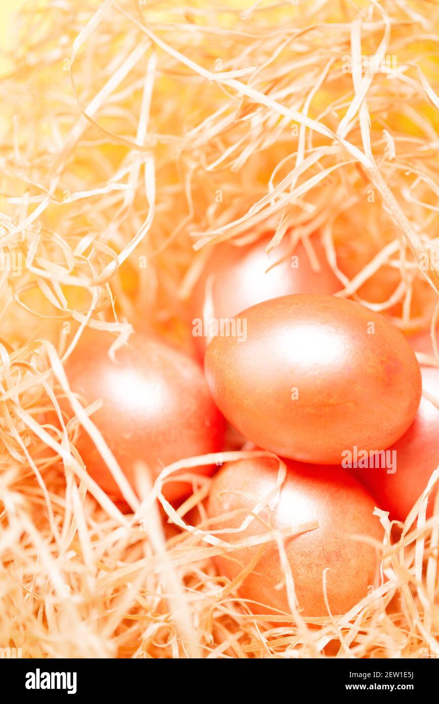 Light happy easter background, pearl pink colored eggs in hay nest ...
