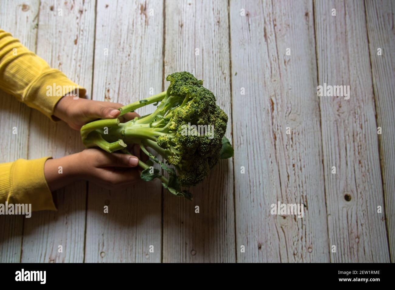 Hand holding raw vegetable on a background Stock Photo - Alamy