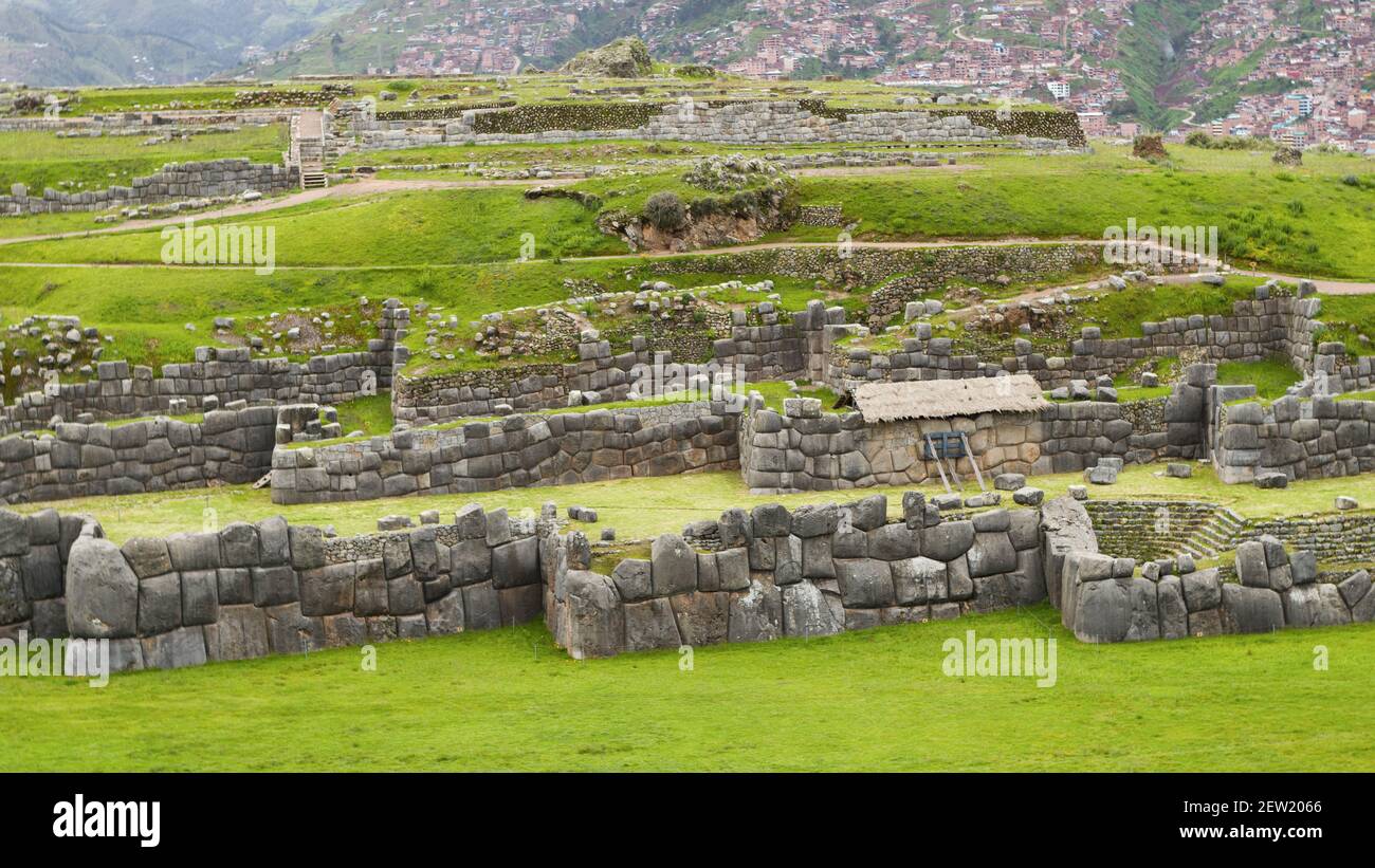 Sacsayhuaman archeological complex with megalithic stones and a hut in ...