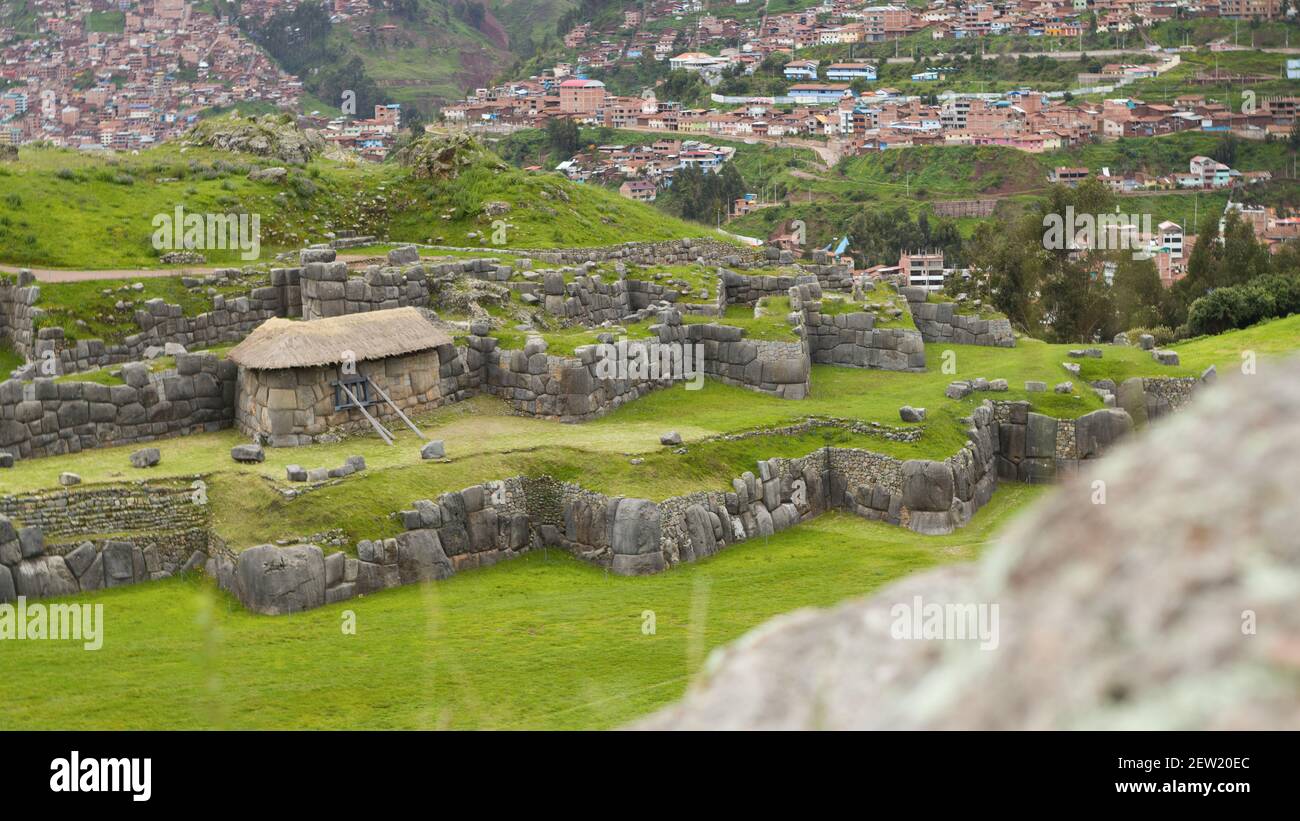 Sacsayhuaman archeological complex with megalithic stones and hut in ...