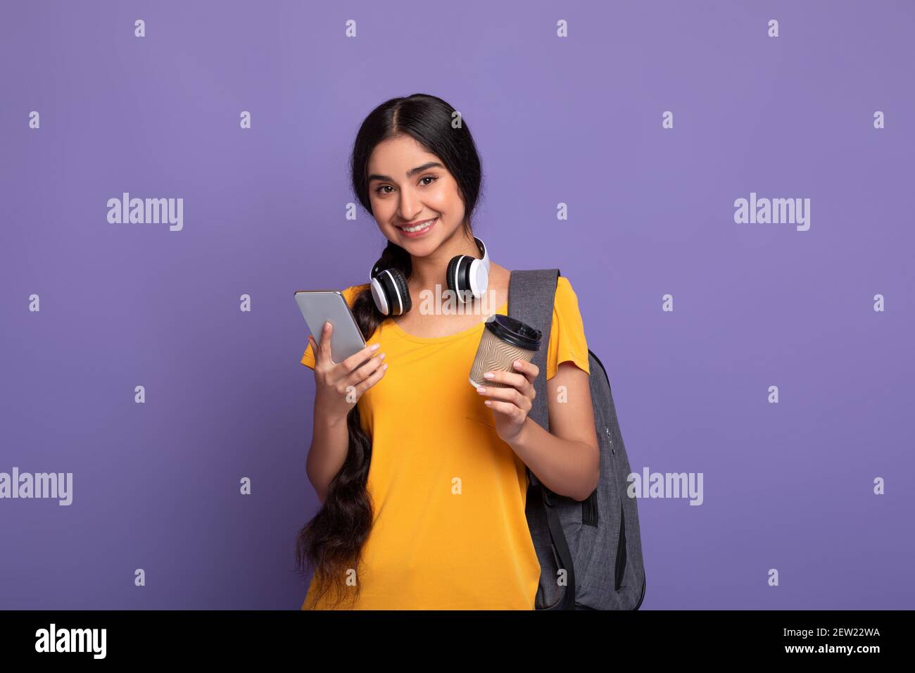 Indian female student holding mobile phone and coffee Stock Photo - Alamy
