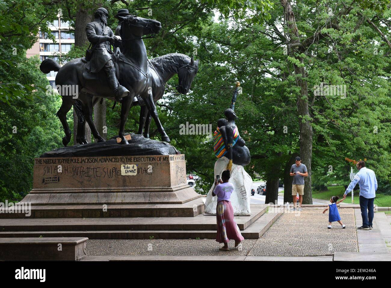 People look at a protest sculpture left at the statue of Confederate ...