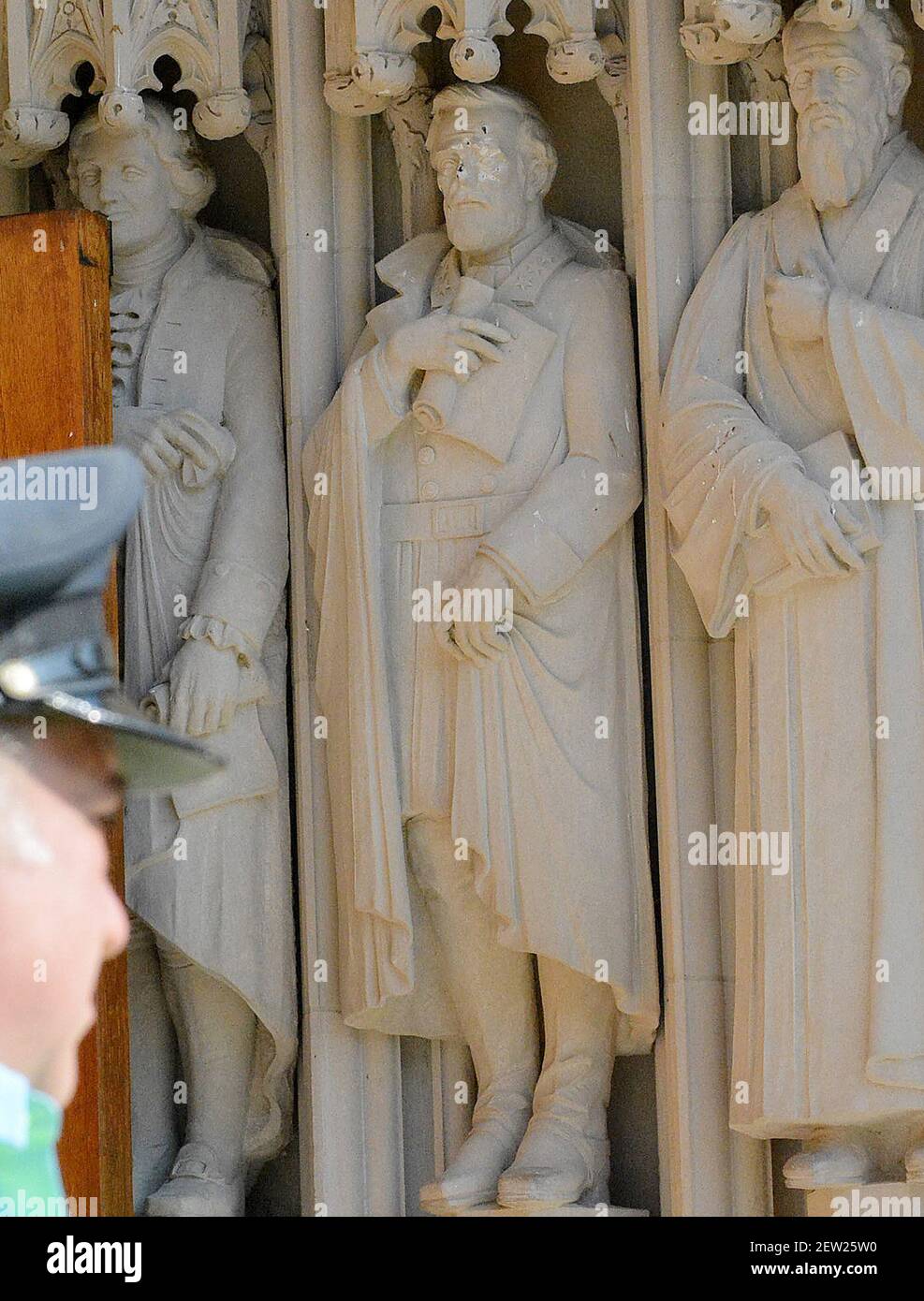 A Duke police officer stands guard after vandals struck the statue of ...