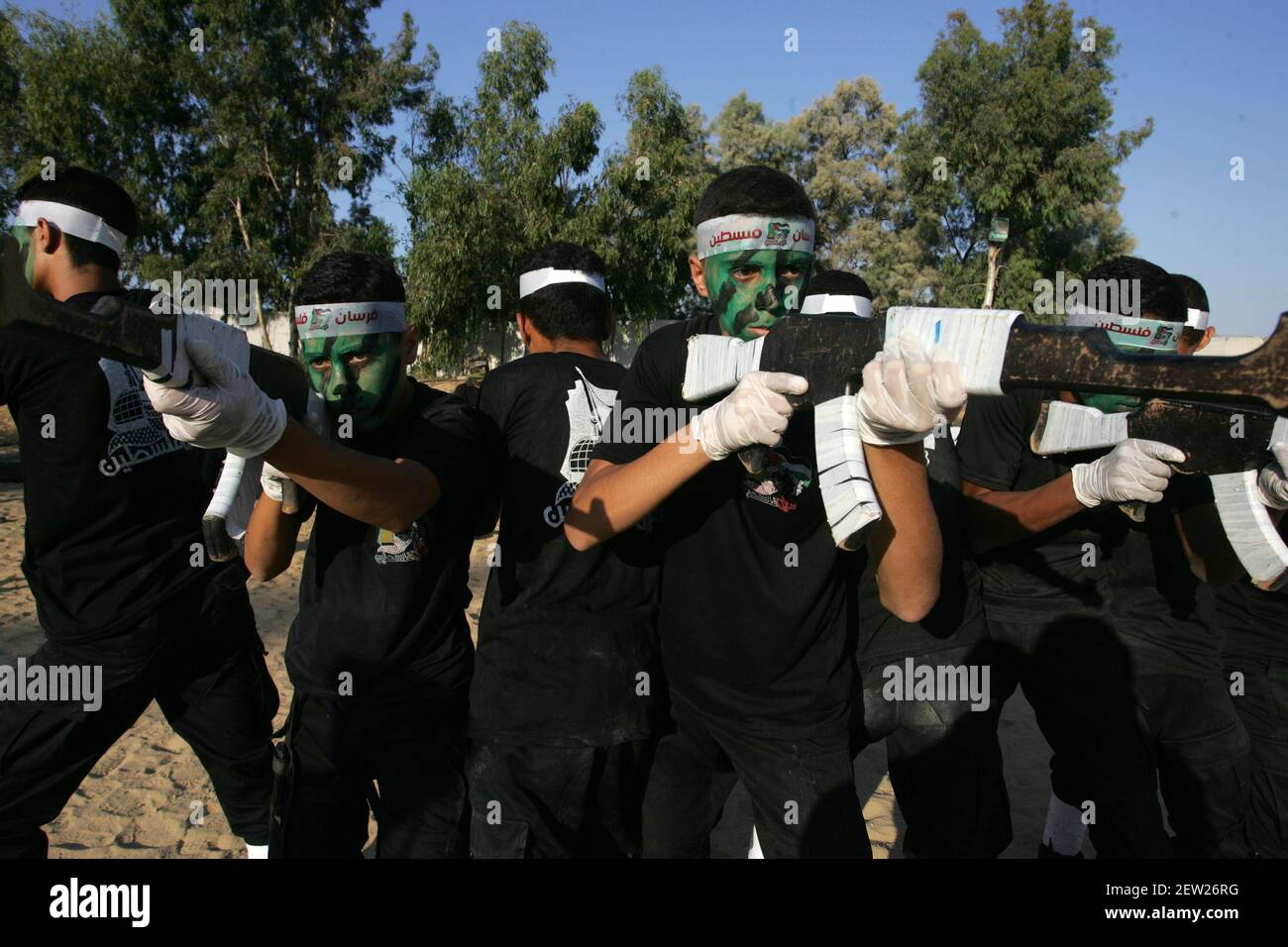 Young Palestinians in action during a military graduation ceremony at a ...