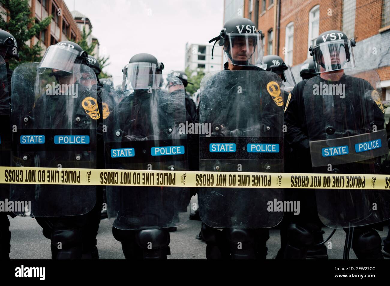 A line of riot police block off the crime scene where the ...