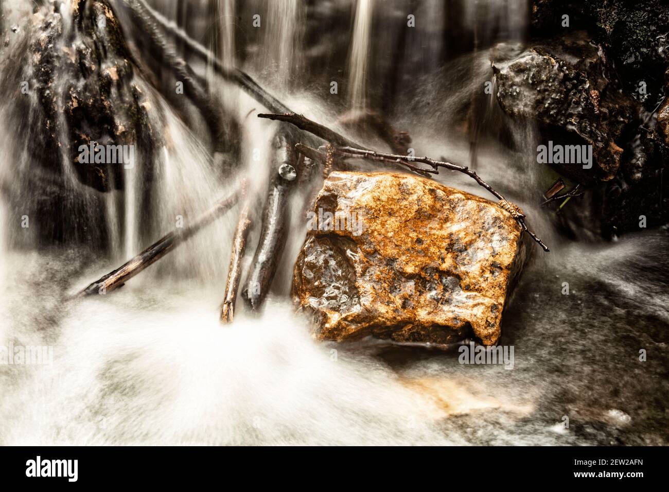 Close up rock and twigs at foot of small waterfall, misty water Stock ...