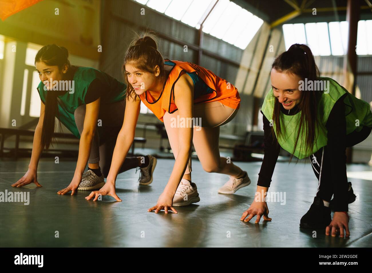Running competition start concept. Three young girls, motivated and ...