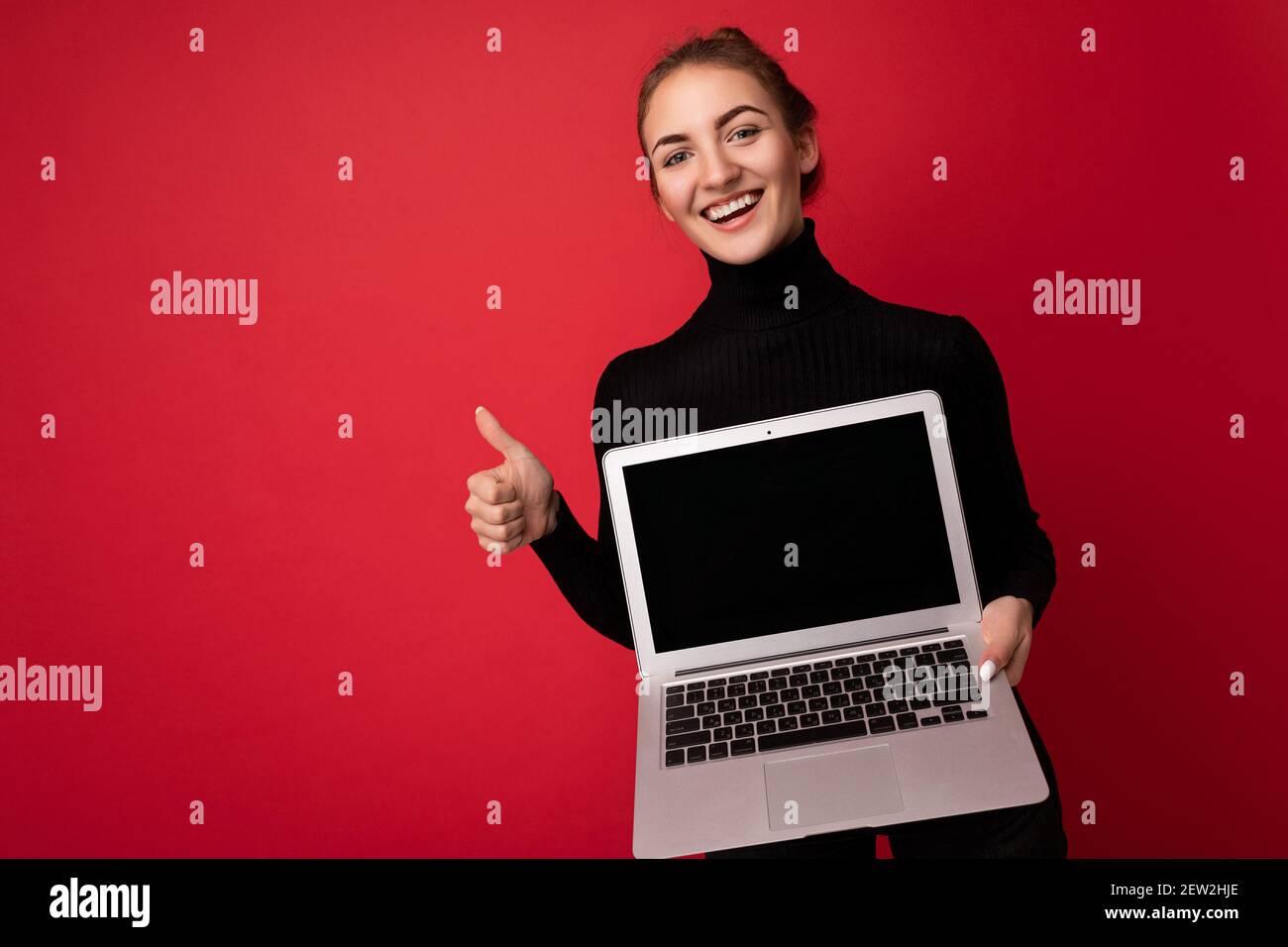 Photo of Beautiful smiling happy young brunette woman holding computer ...