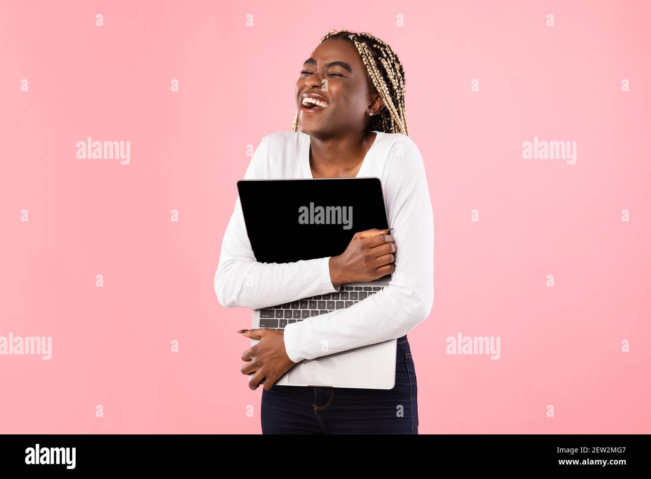 Excited black woman hugging personal computer at studio Stock Photo - Alamy