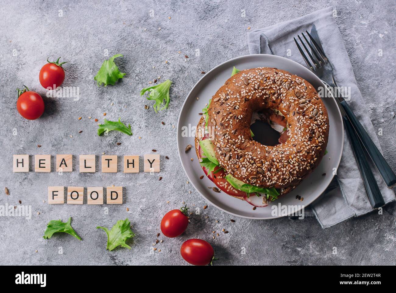 Healthy Food Snack Lunch. Bagel with avocado, tomato, radish and green ...