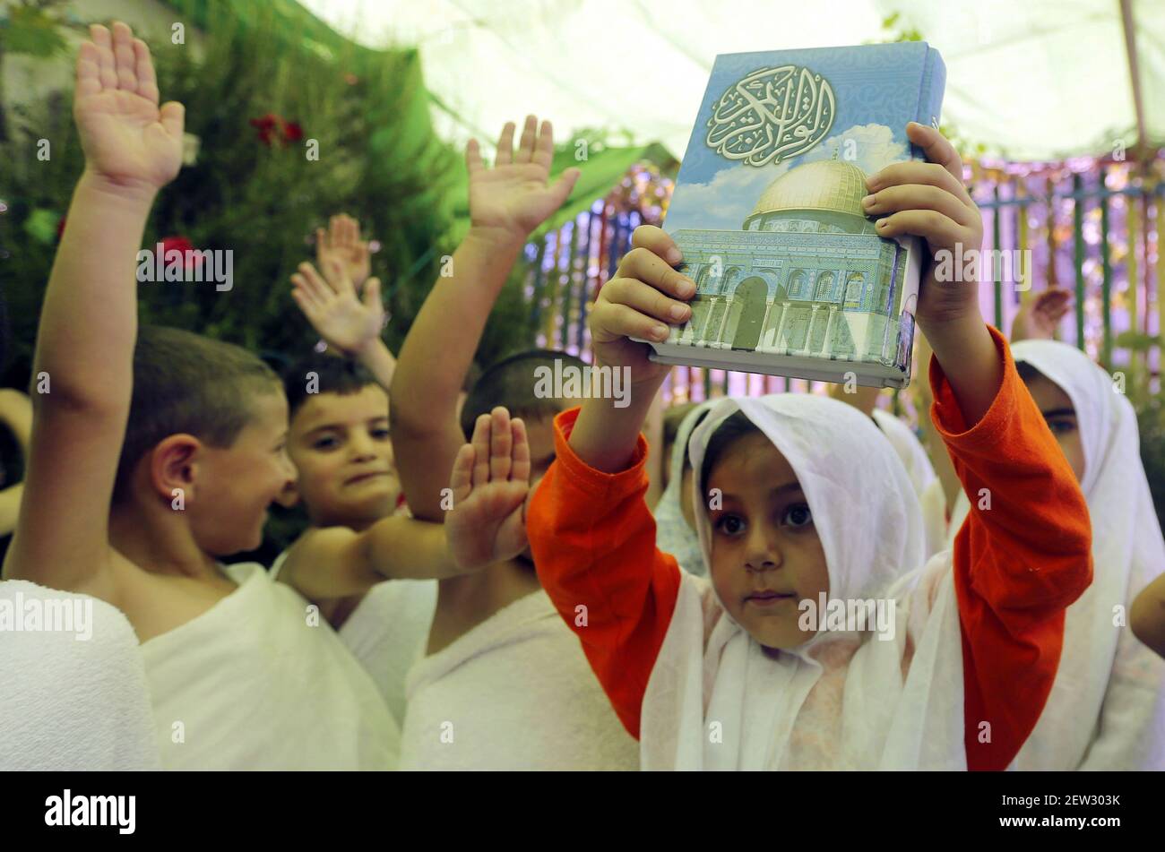 Palestinian children gather around a makeshift cube representing the ...