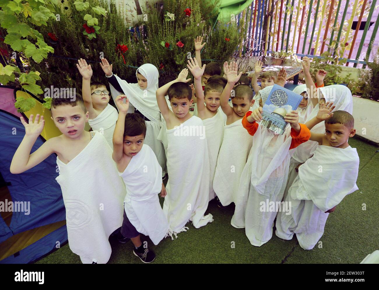 Palestinian children gather around a makeshift cube representing the ...