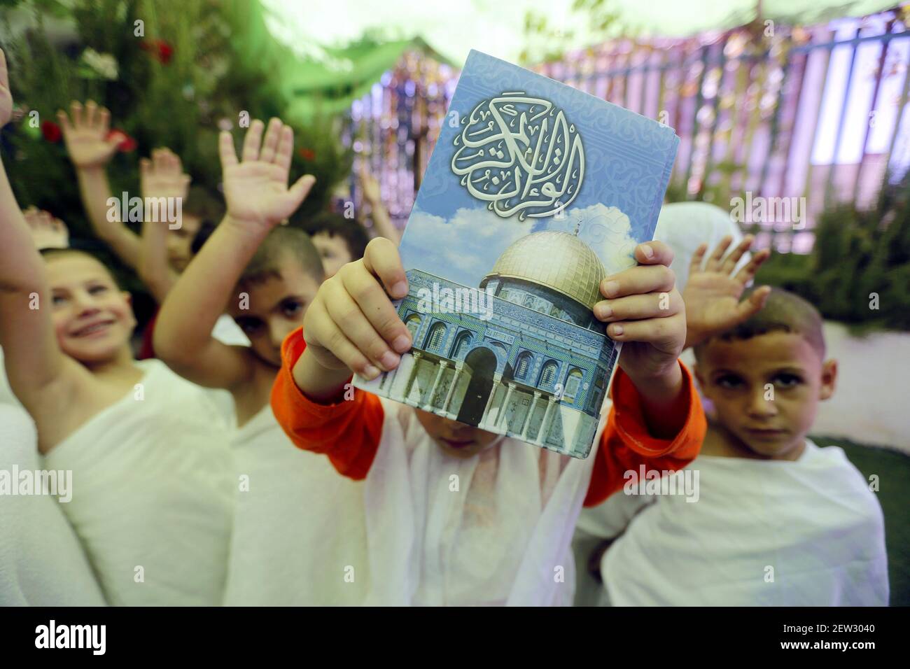 Palestinian children gather around a makeshift cube representing the ...