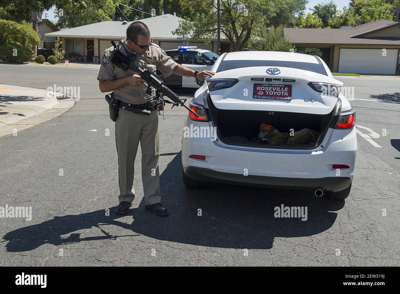 California Highway Patrol officers look for suspects in the trunk of a ...