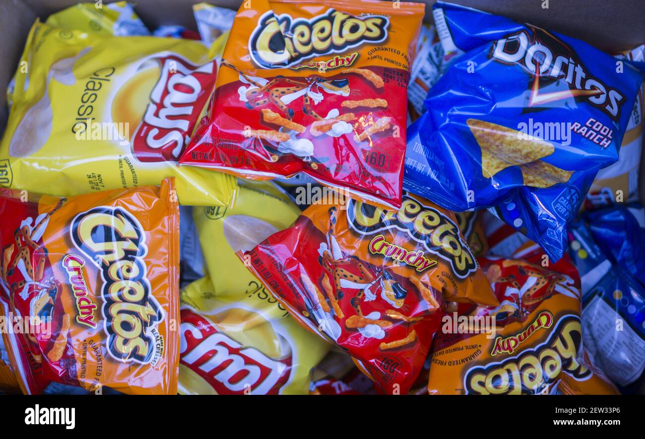 A display of tasty Frito-Lay brand chips and snacks in a supermarket in ...