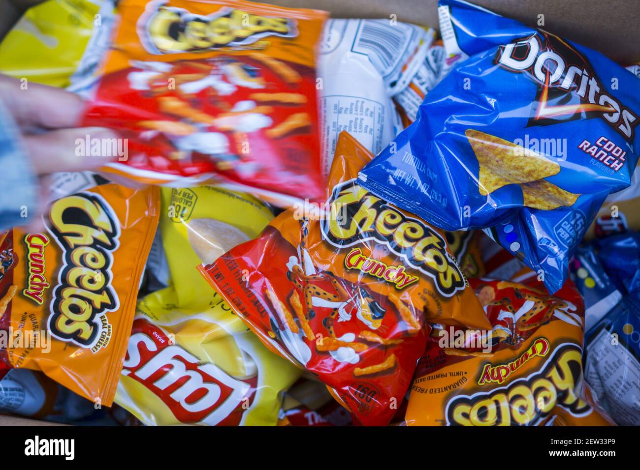 A display of tasty Frito-Lay brand chips and snacks in a supermarket in ...