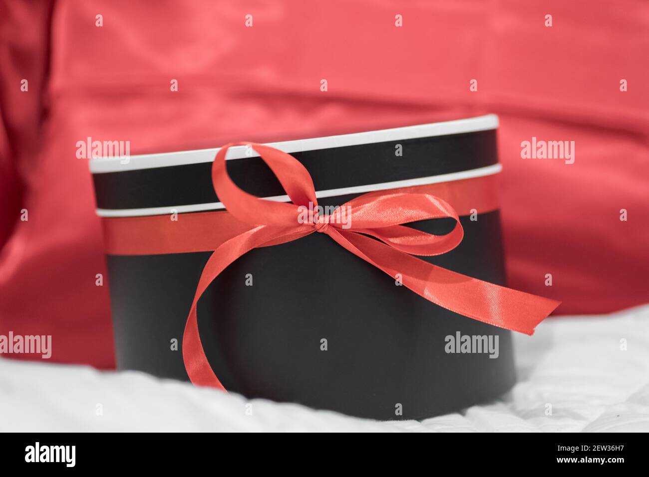 gift surprise box with red ribbon close up Stock Photo - Alamy