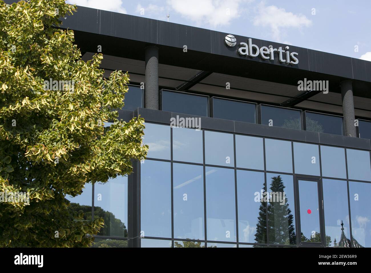 A logo sign outside of the headquarters of Abertis Infraestructuras in ...