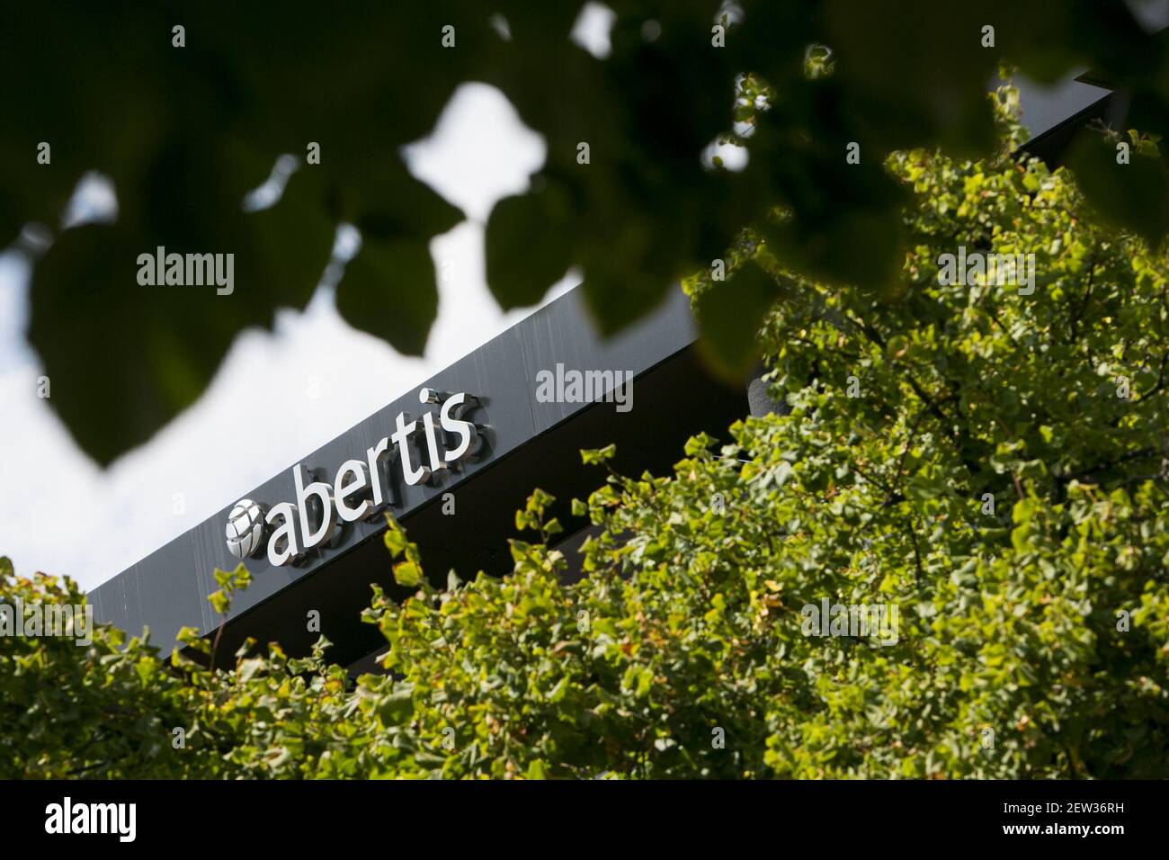 A logo sign outside of the headquarters of Abertis Infraestructuras in ...