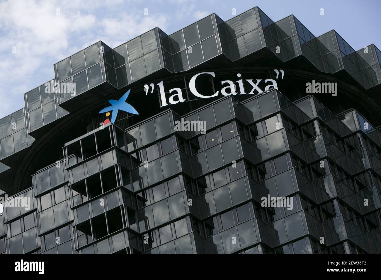 A logo sign outside of the headquarters of the La Caixa group and Caixa ...