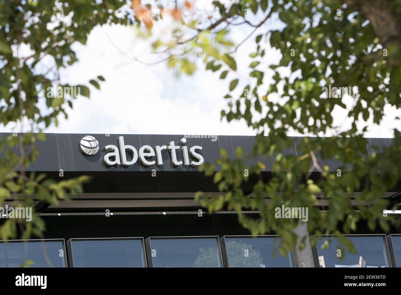 A logo sign outside of the headquarters of Abertis Infraestructuras in ...