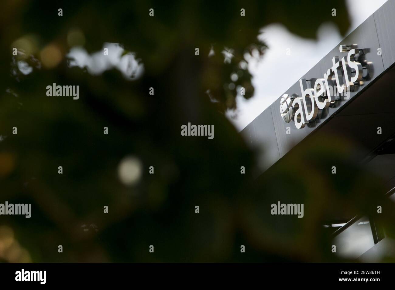 A logo sign outside of the headquarters of Abertis Infraestructuras in ...
