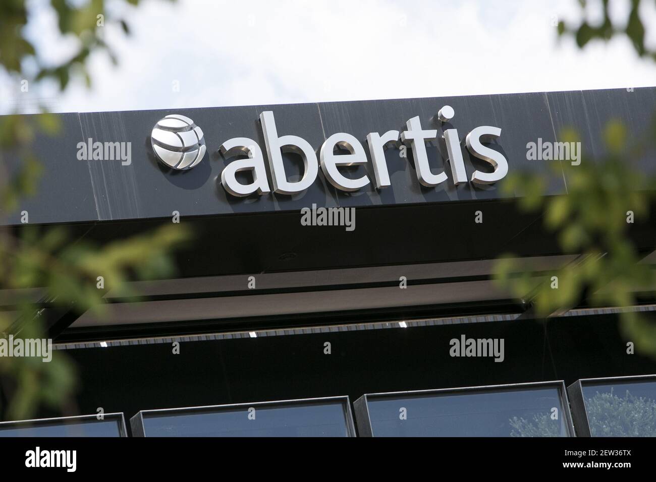A logo sign outside of the headquarters of Abertis Infraestructuras in ...